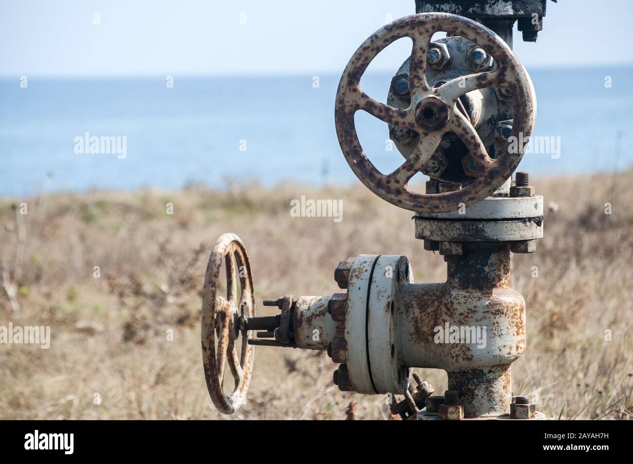 Old rusty weathered aged valve of abandoned pipe system equipment ...