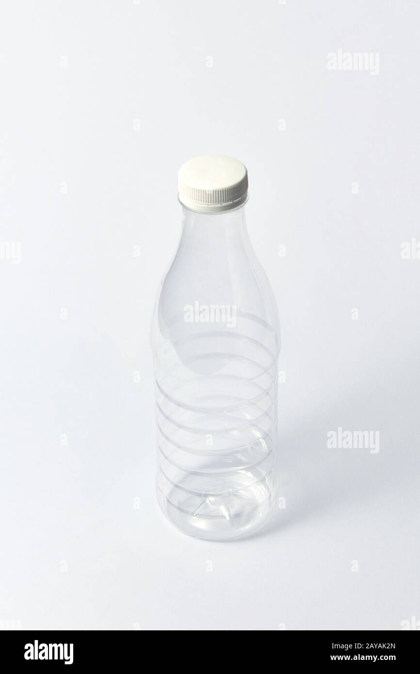 Transparent empty bottle for liquid on a light background. Mock up ...