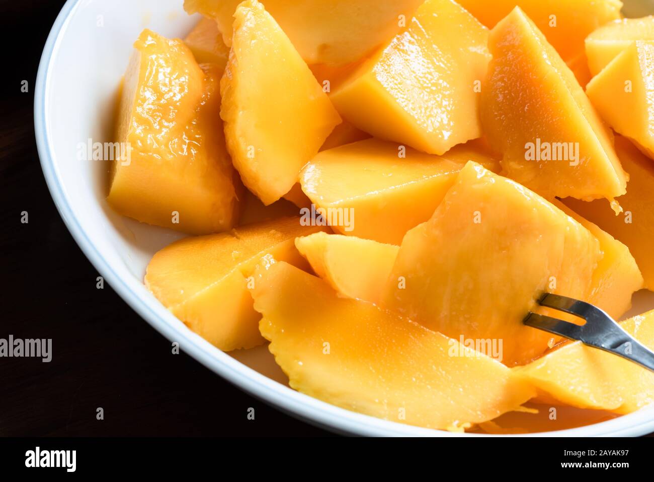 yellow mango on a dish Stock Photo - Alamy