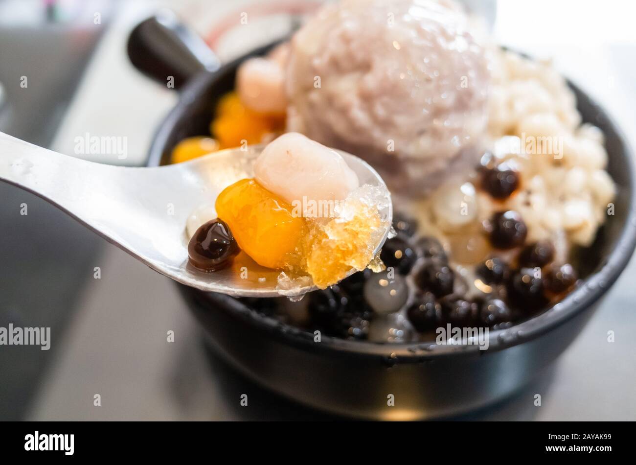 eating shaved ice with colorful dessert Stock Photo - Alamy