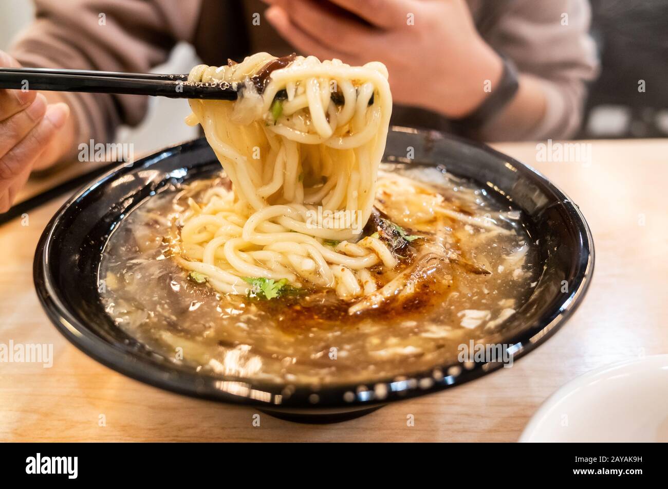 Woman noodles eating hi-res stock photography and images - Alamy