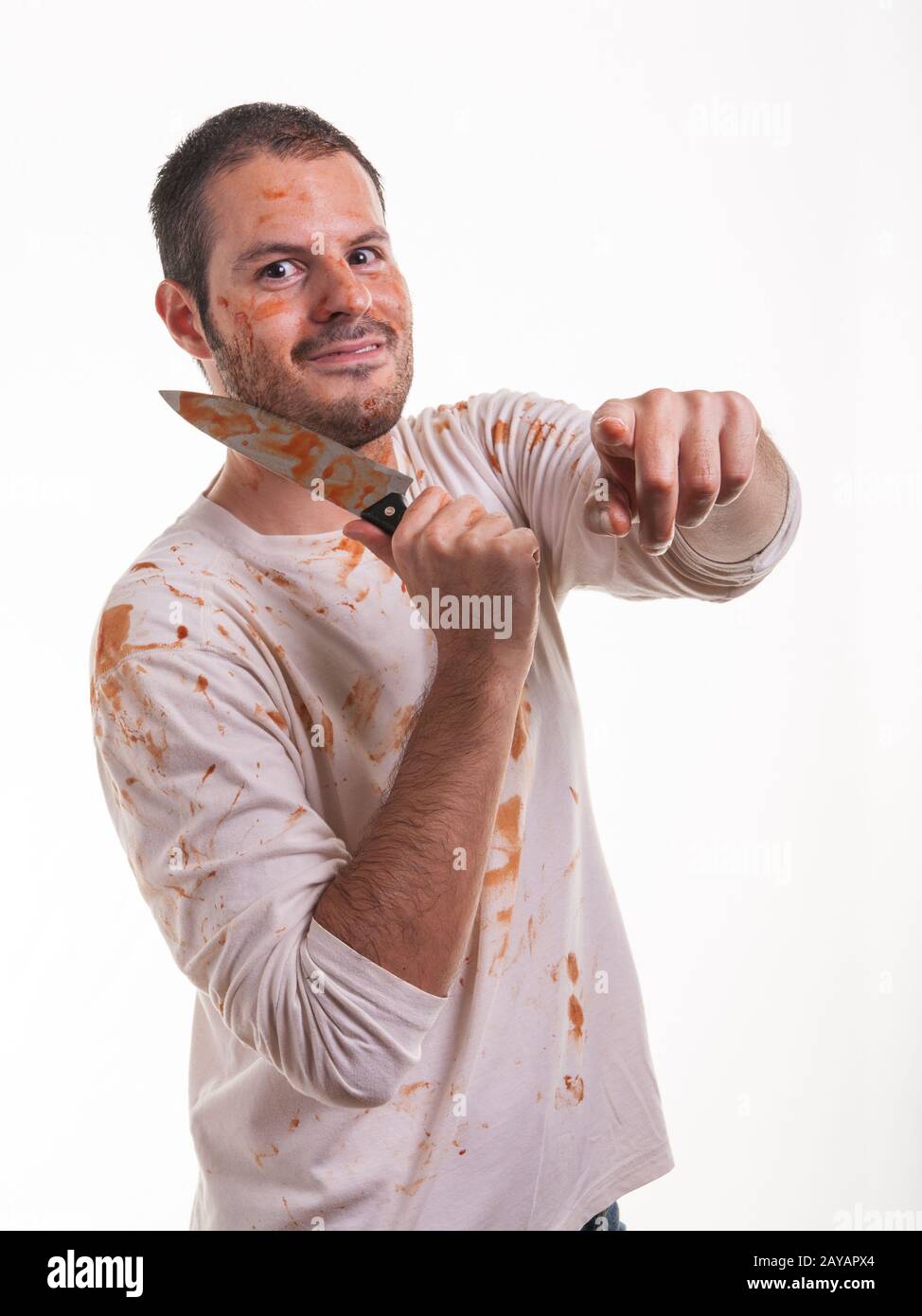 A bloody scene with a man and a blood-covered knife in his hand ...