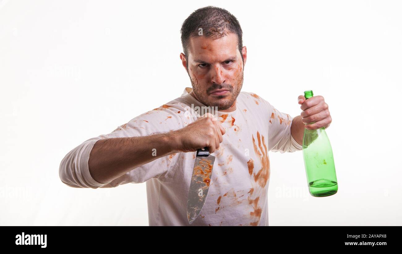 A bloody scene with a man and a blood-covered knife in his hand ...