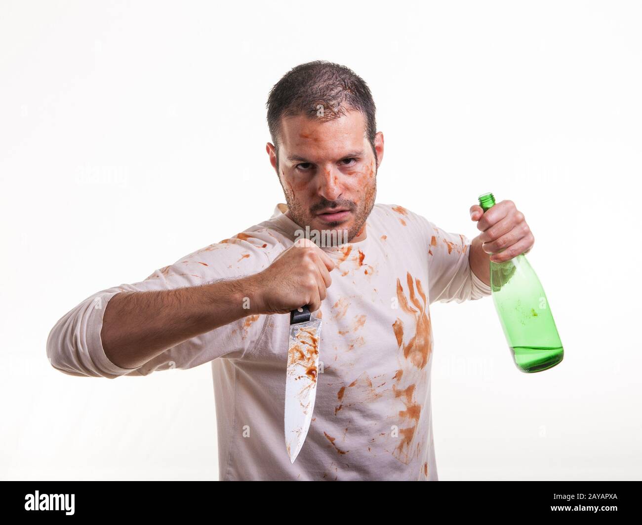 A bloody scene with a man and a blood-covered knife in his hand ...