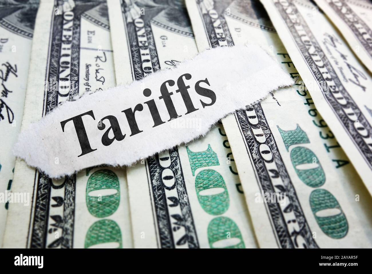 Tariffs newspaper headline on money Stock Photo - Alamy