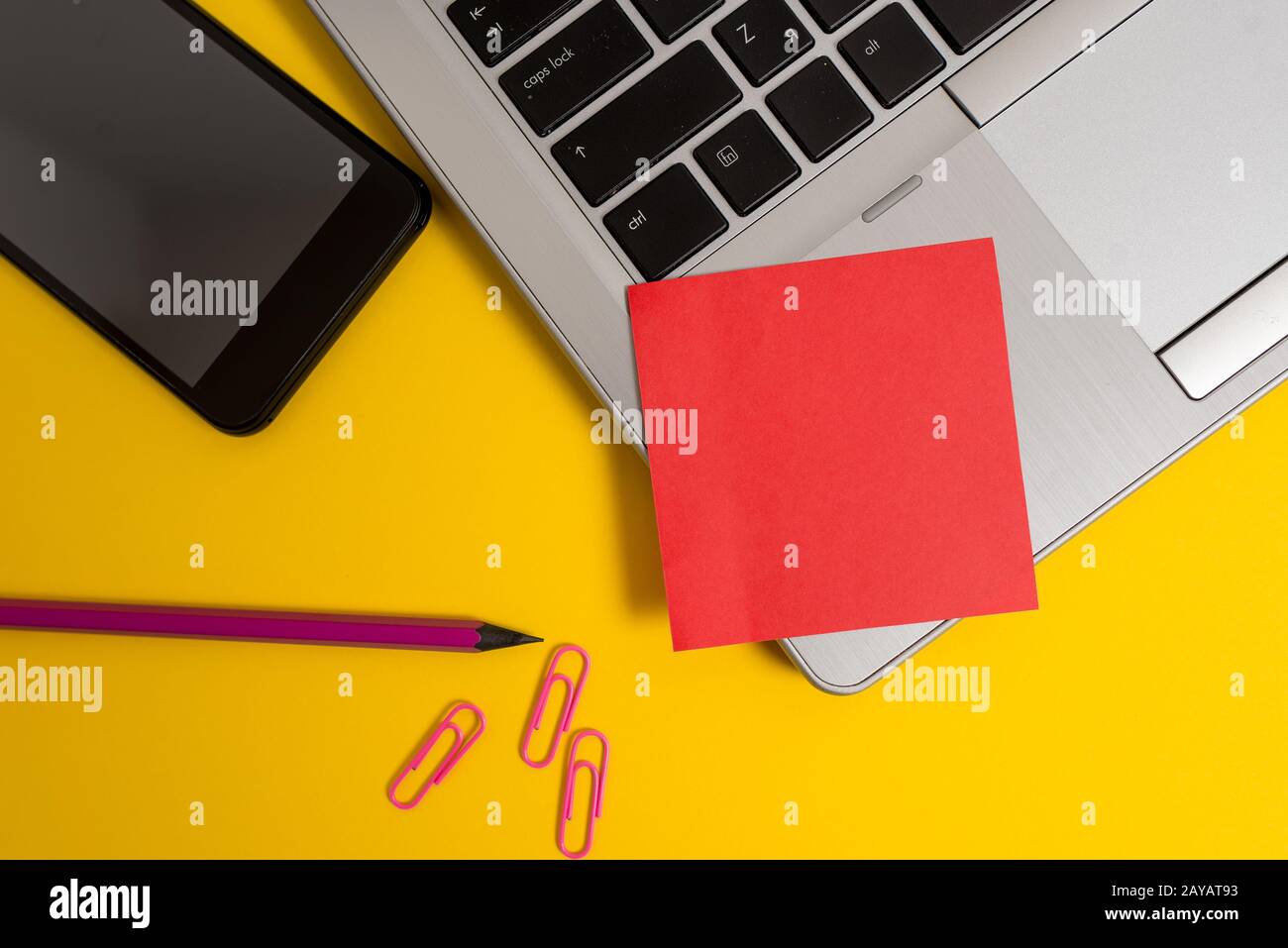 Part view trendy metallic laptop blank sticky note smartphone pencil ...