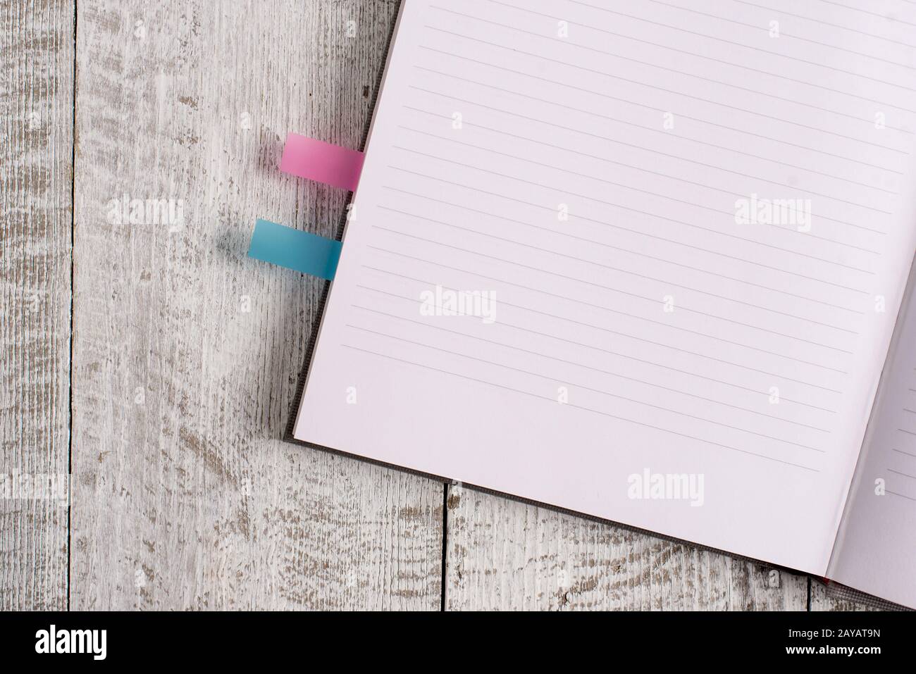 Thick pages notebook stationary on the top of a wooden table. Writing ...