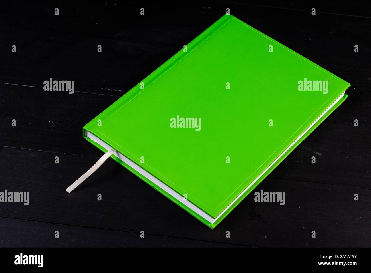 Front view closed colored notebook bookmark inside. Abstract background ...