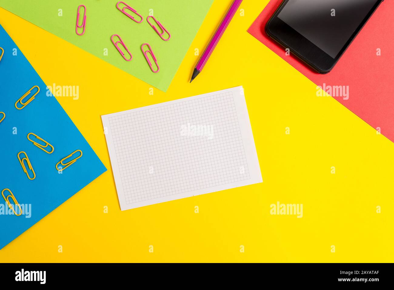 Blank colored paper sheets clips smartphone squared notepad pencil ...