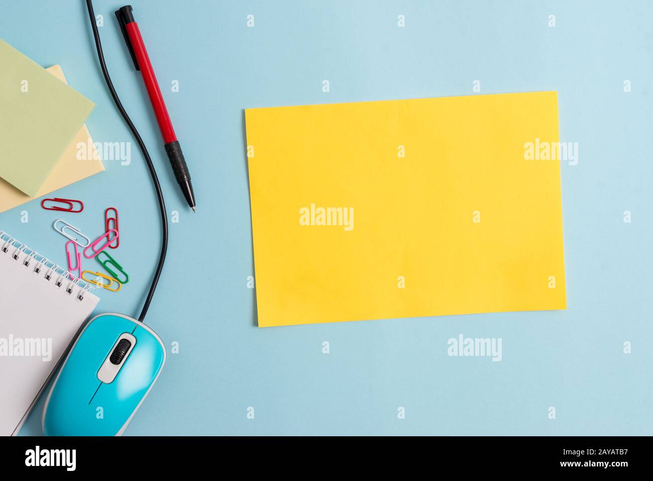Cardboard and writing equipment with modern gadget above pastel ...