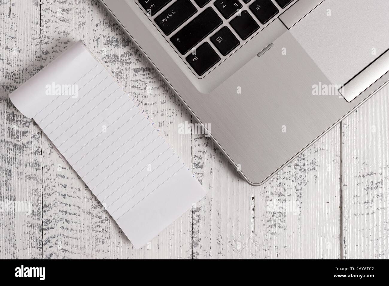 Trendy metallic laptop ruled notepad lying wooden rustic vintage table ...