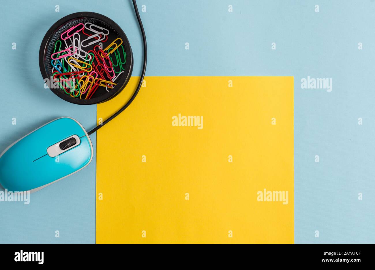 Cardboard and writing equipment with modern gadget above pastel ...