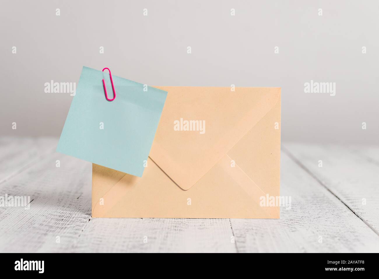 Closed standing rectangular colored envelope sticky note clip lying ...
