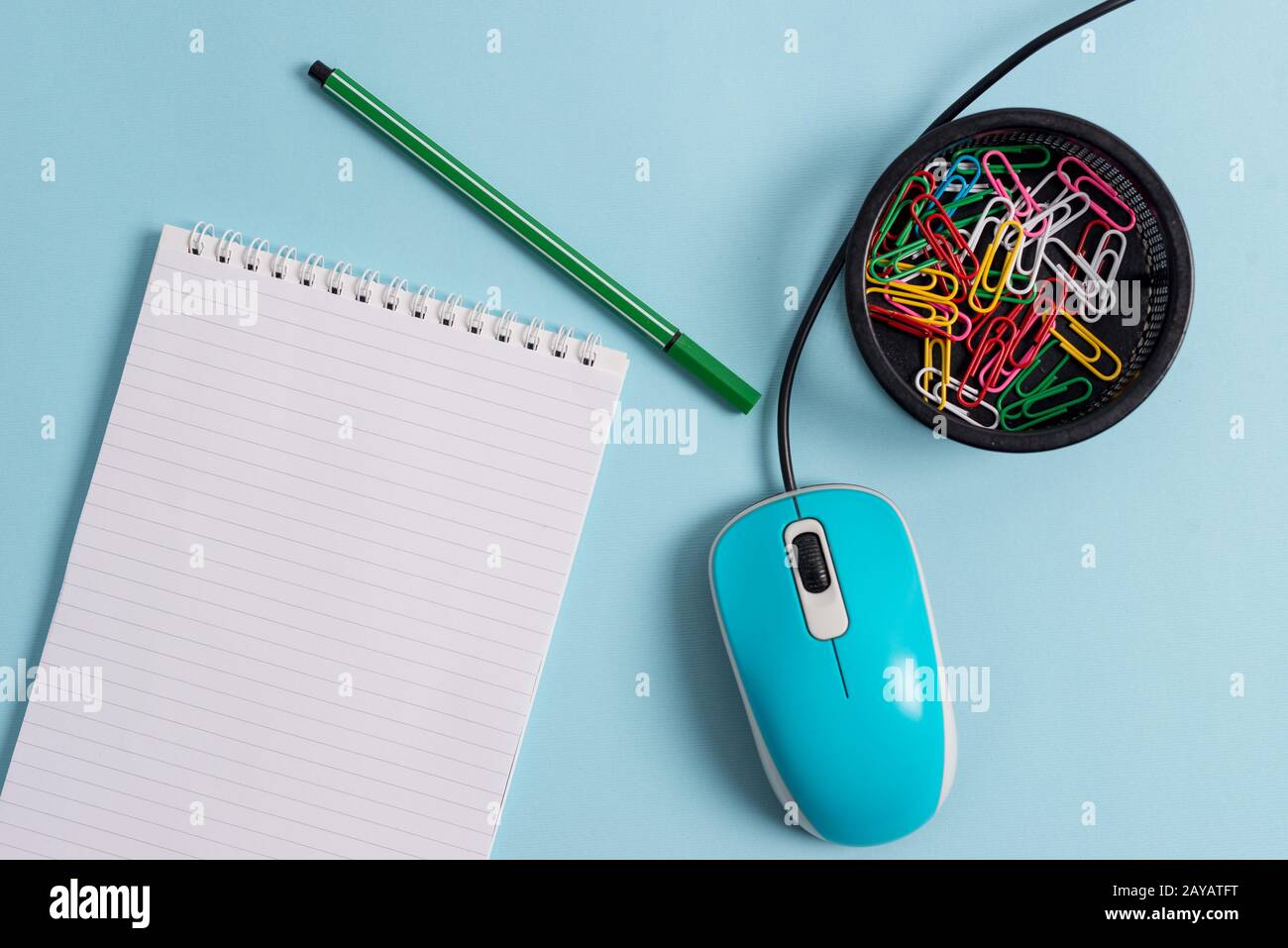 Notebook and writing equipment with computer tool above pastel backdrop ...