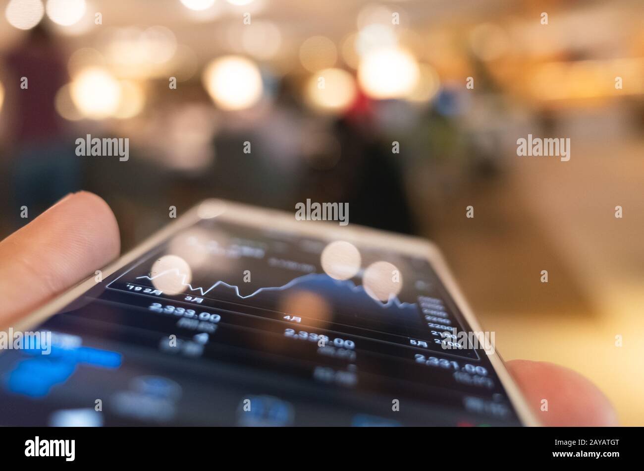 using a mobile device to check market data Stock Photo - Alamy
