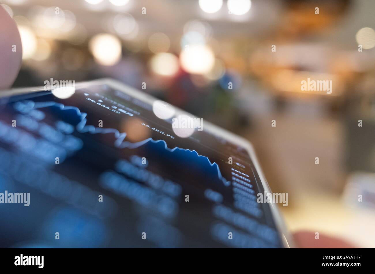using a mobile device to check market data Stock Photo - Alamy