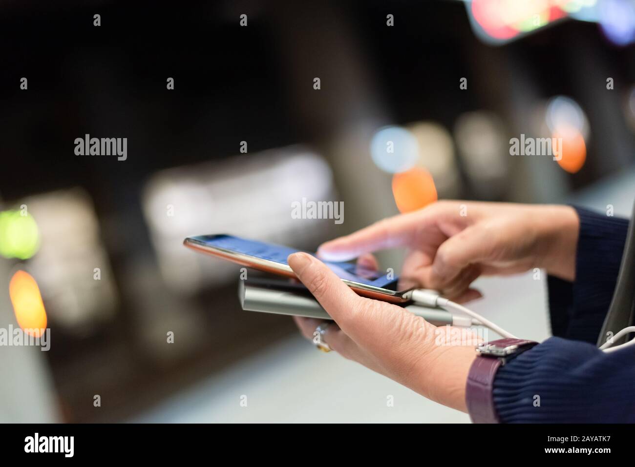 using cellphone in the rail station Stock Photo - Alamy