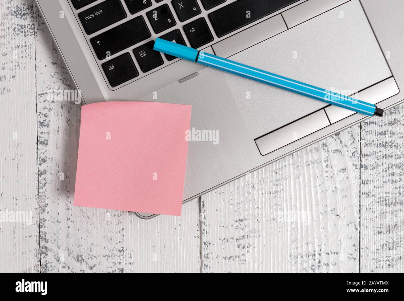 Trendy metallic laptop sticky note pen ballpoint lying wooden rustic ...