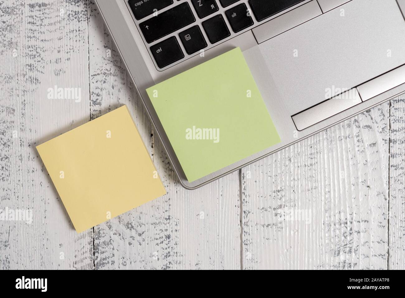 Trendy metallic laptop two sticky note pads lying wooden rustic vintage ...