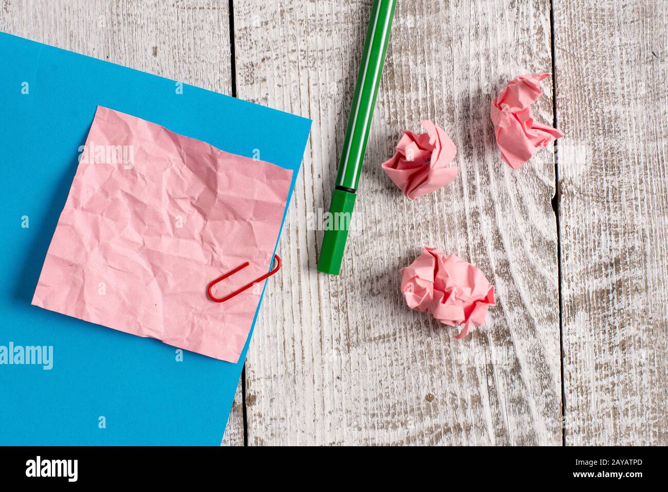 Crumpled note paper and blank cardboard above wooden table. Wrinkle ...