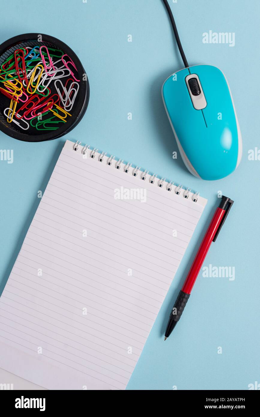 Notebook and writing equipment with computer tool above pastel backdrop ...