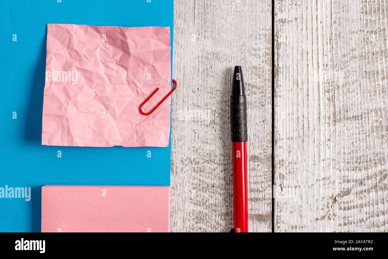 Crumpled note paper and blank cardboard above wooden table. Wrinkle ...