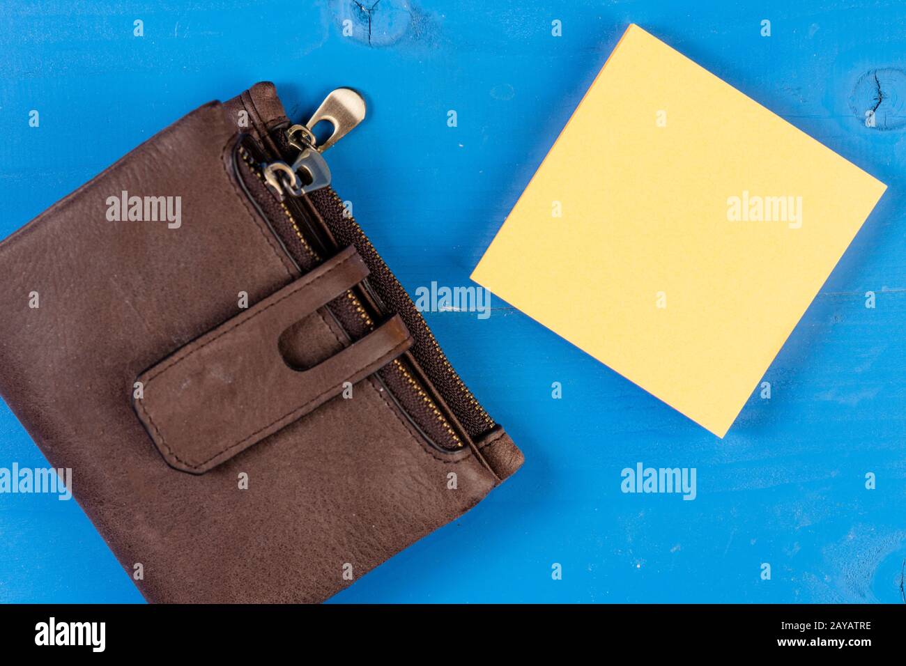 Front view leather coin purse wallet colored sticky notes pad wooden ...