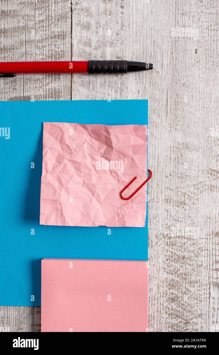 Crumpled note paper and blank cardboard above wooden table. Wrinkle ...