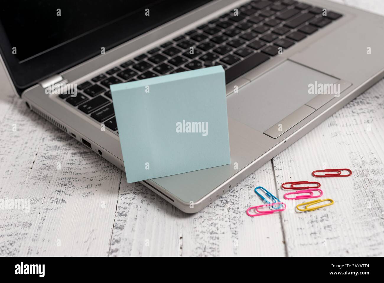 Trendy metallic laptop sticky notes colored clips lying wooden rustic ...
