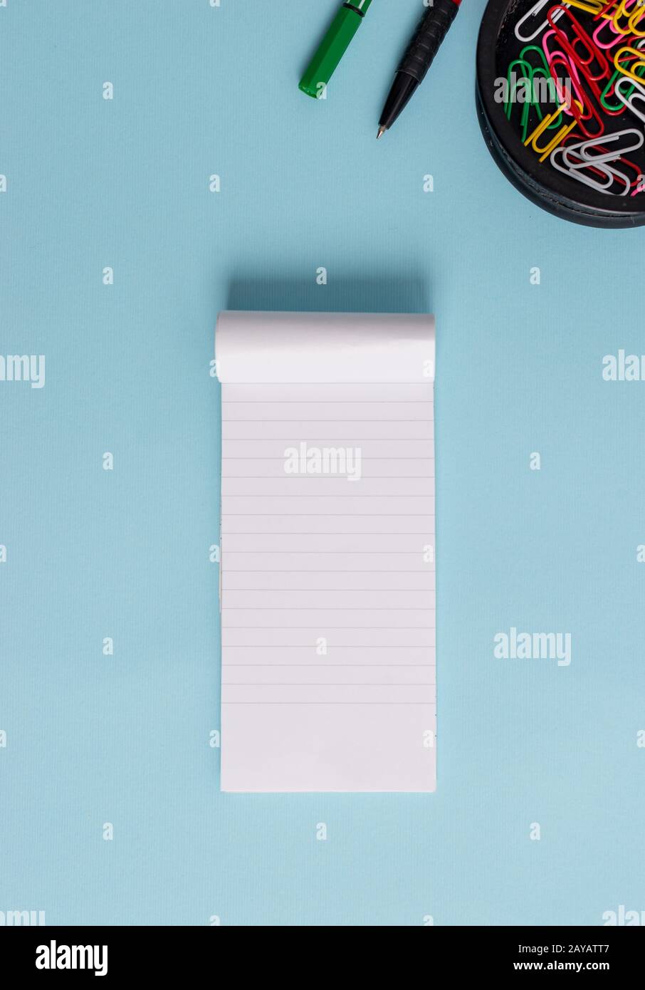 Notebook and writing equipment with computer tool above pastel backdrop ...