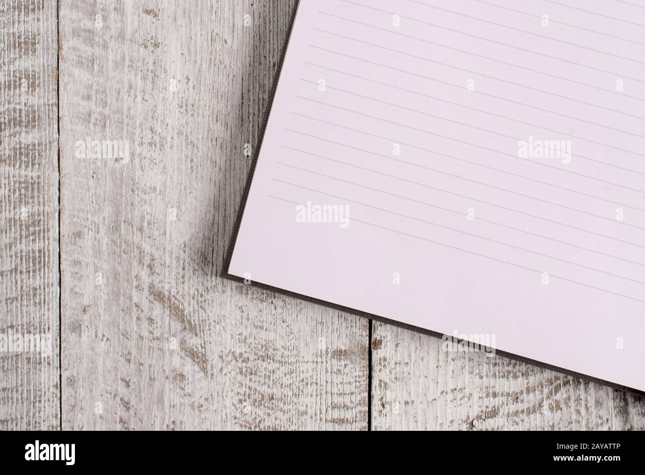 Thick pages notebook stationary on the top of a wooden table. Writing ...