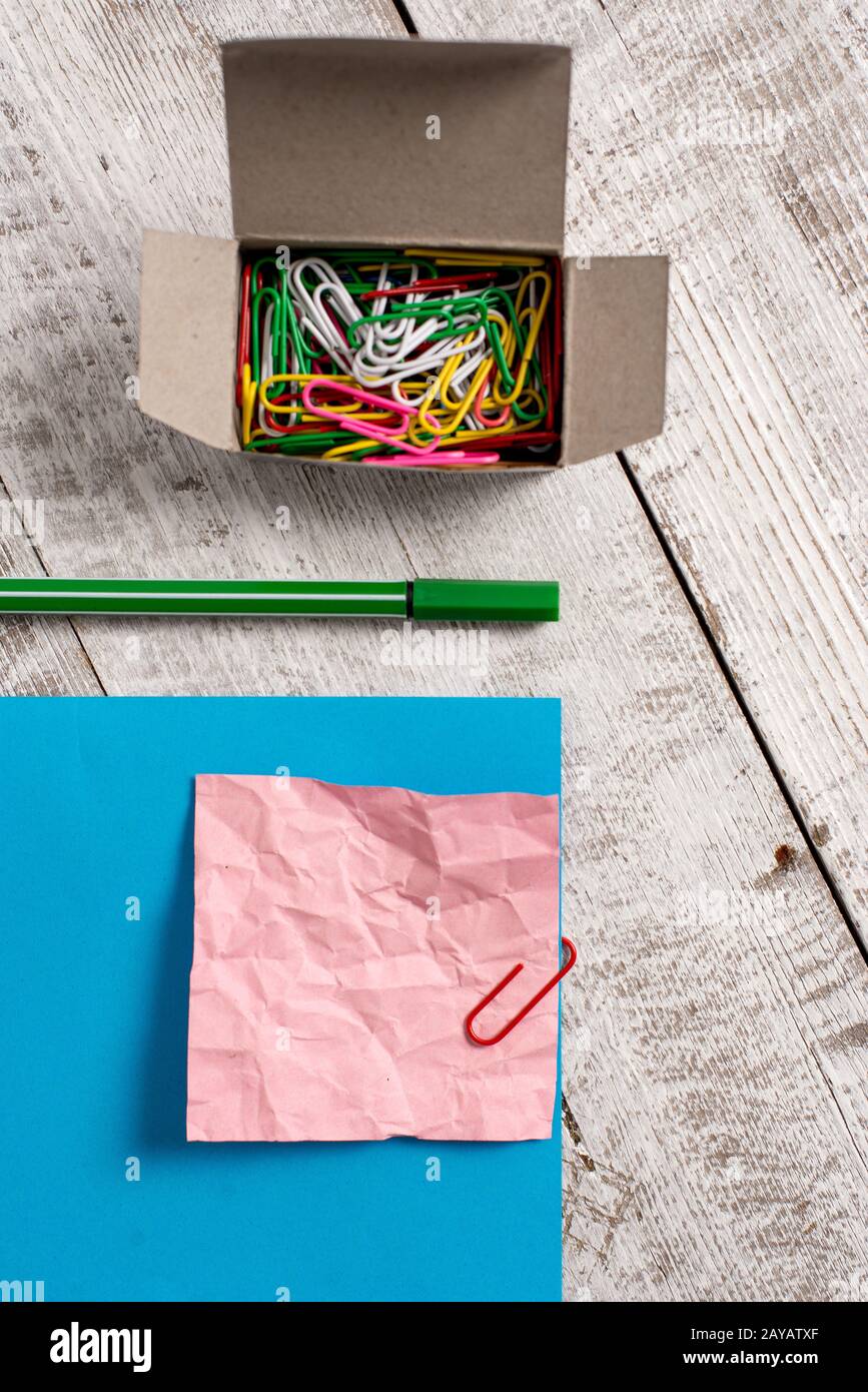Crumpled note paper and blank cardboard above wooden table. Wrinkle ...