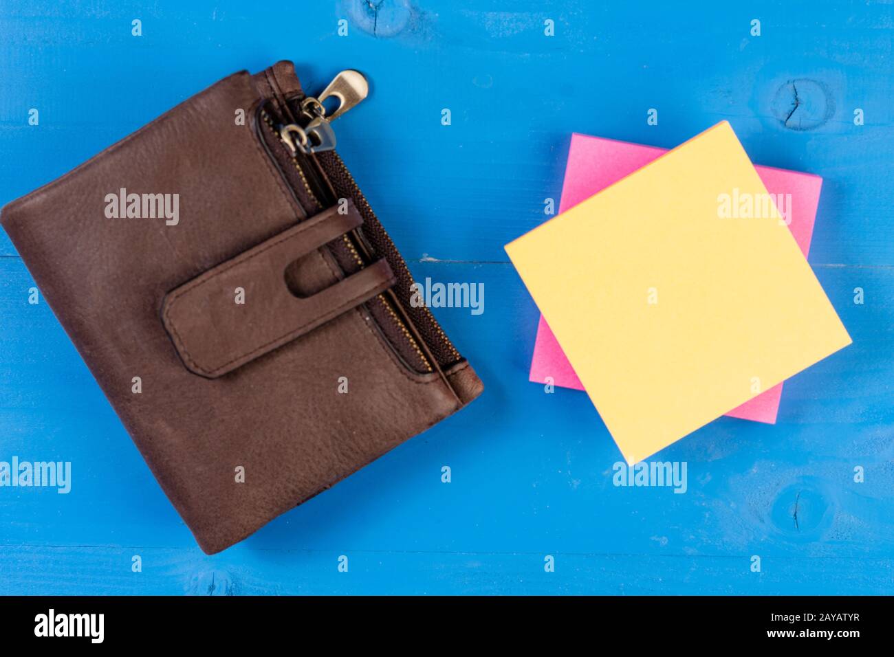 Front view leather coin purse wallet colored sticky notes pad wooden ...