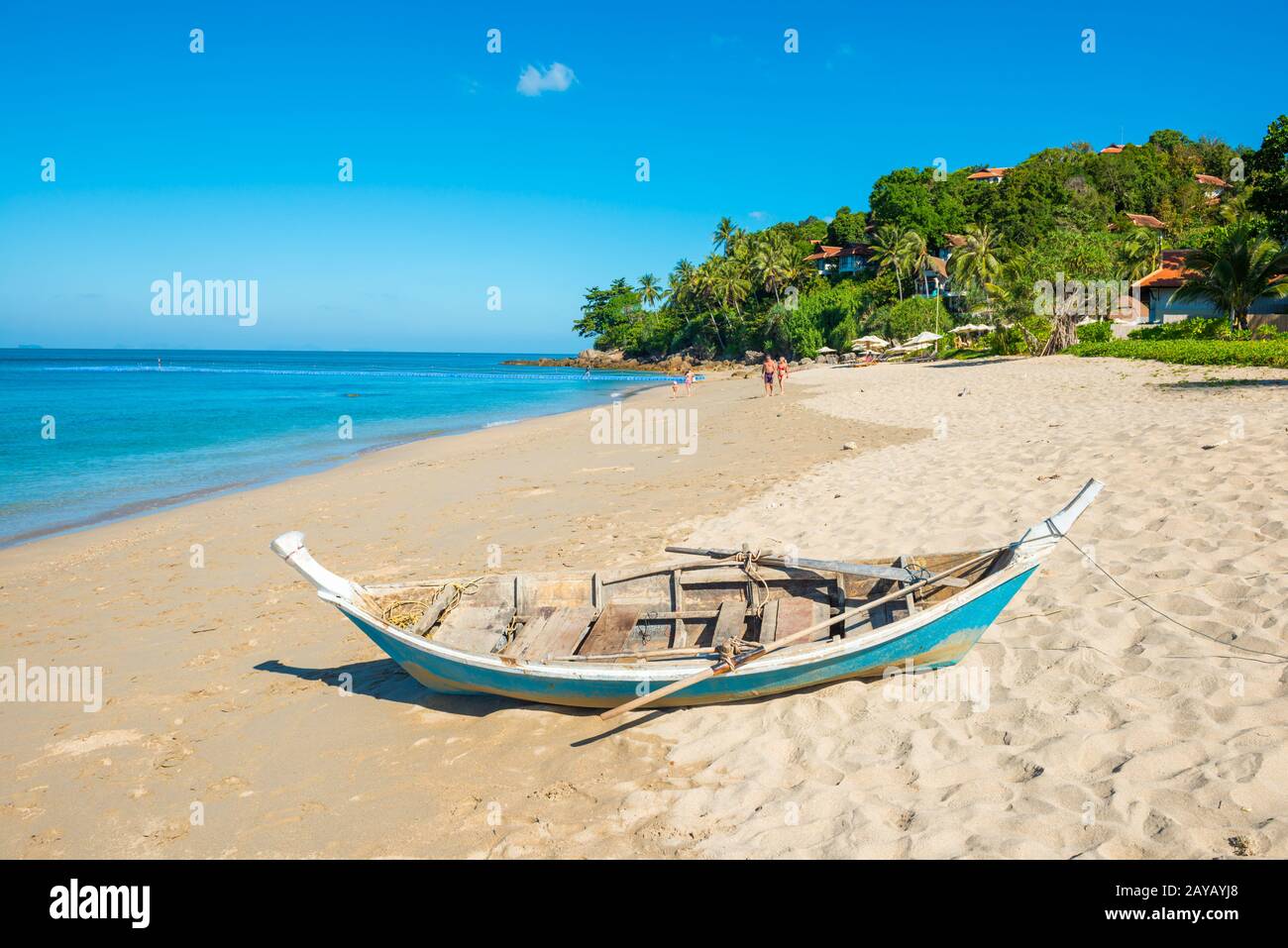 Tropical landscape with boat at sand beach Stock Photo - Alamy