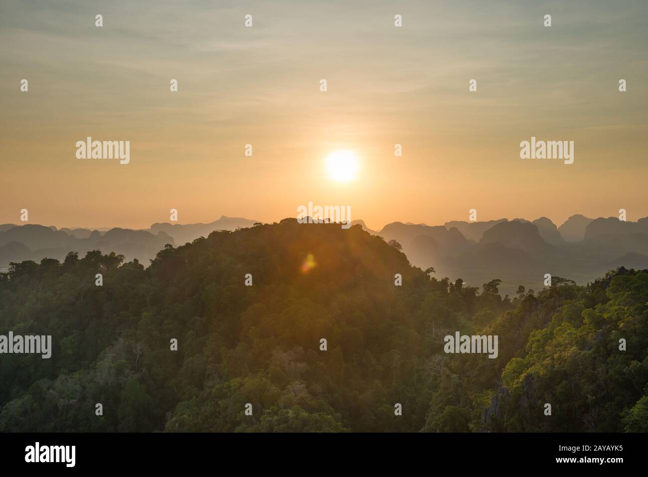 Tropical landscape with steep mountains at sunset Stock Photo - Alamy