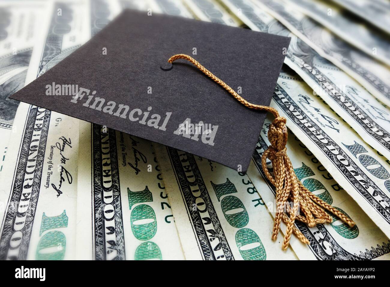 Financial Aid graduation cap on money Stock Photo - Alamy