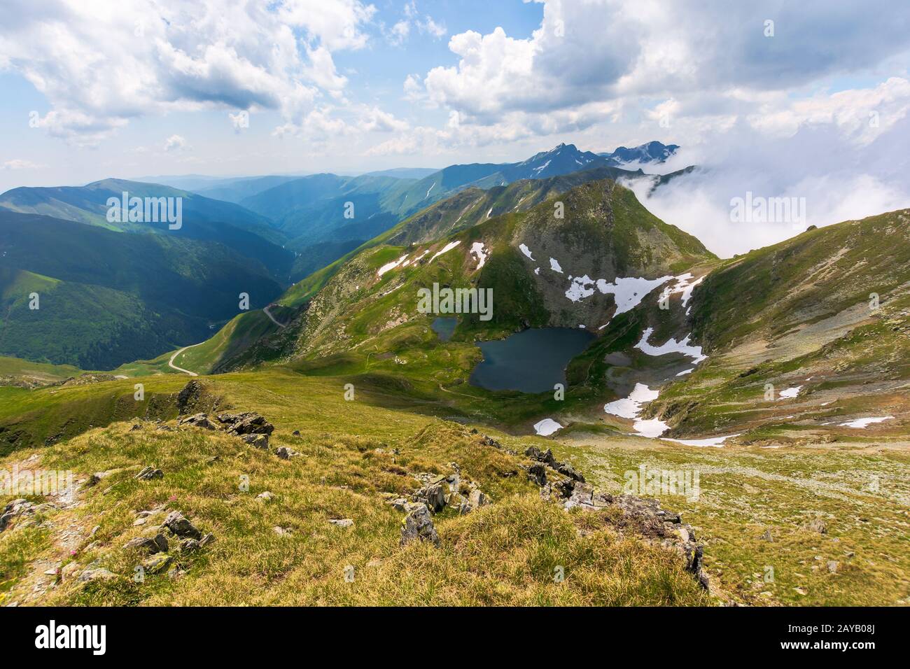 great summer scenery of high mountain range with alpine lake. steep ...