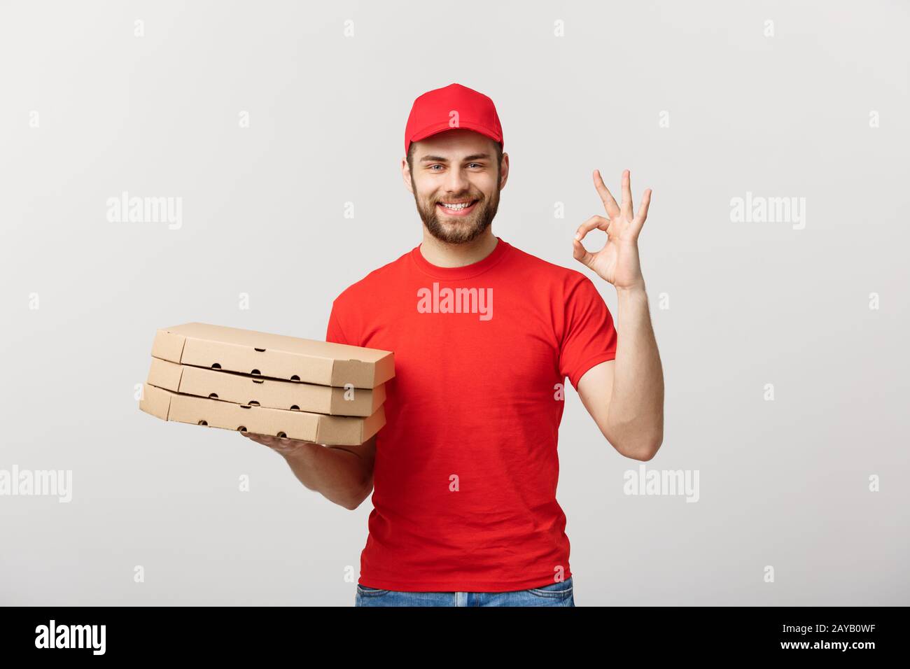 Delivery Concept: Handsome pizza delivery man making OK sign isolated ...