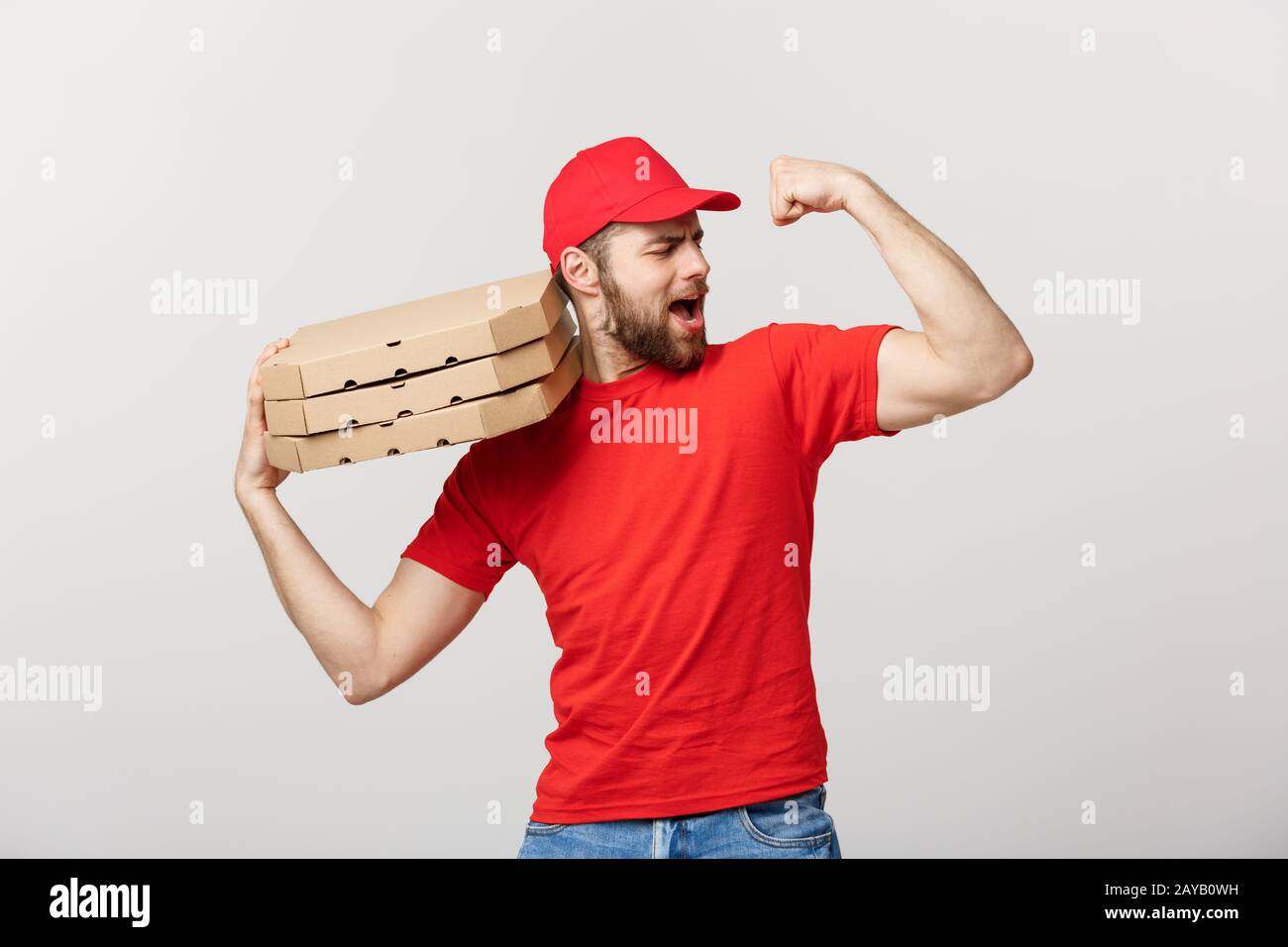 Delivery Concept - Portrait of Strong handsome delivery man flexing his ...