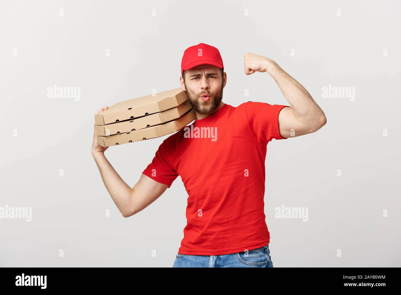 Delivery Concept - Portrait of Strong handsome delivery man flexing his ...