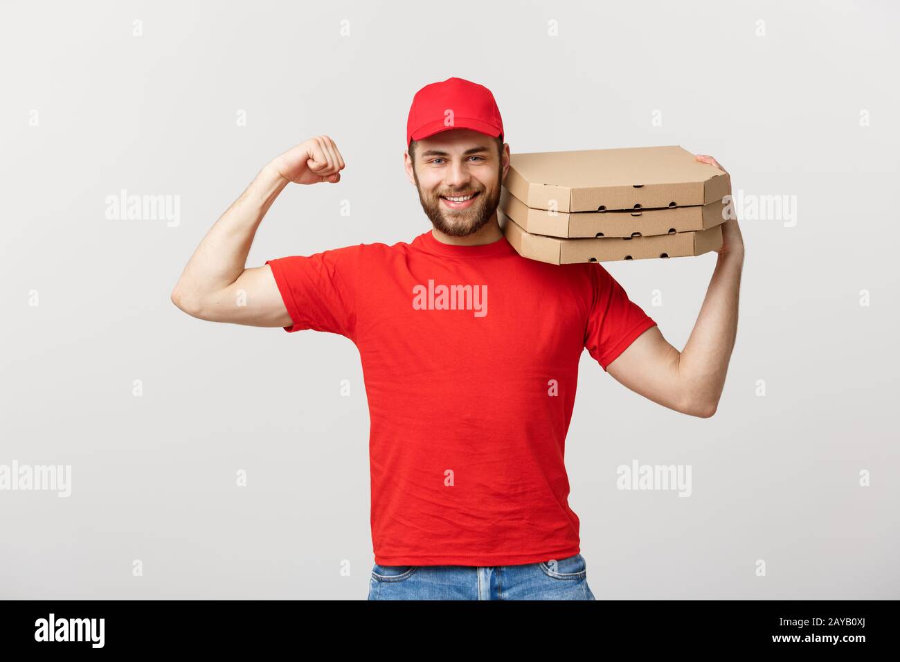 Delivery Concept - Portrait of Strong handsome delivery man flexing his ...