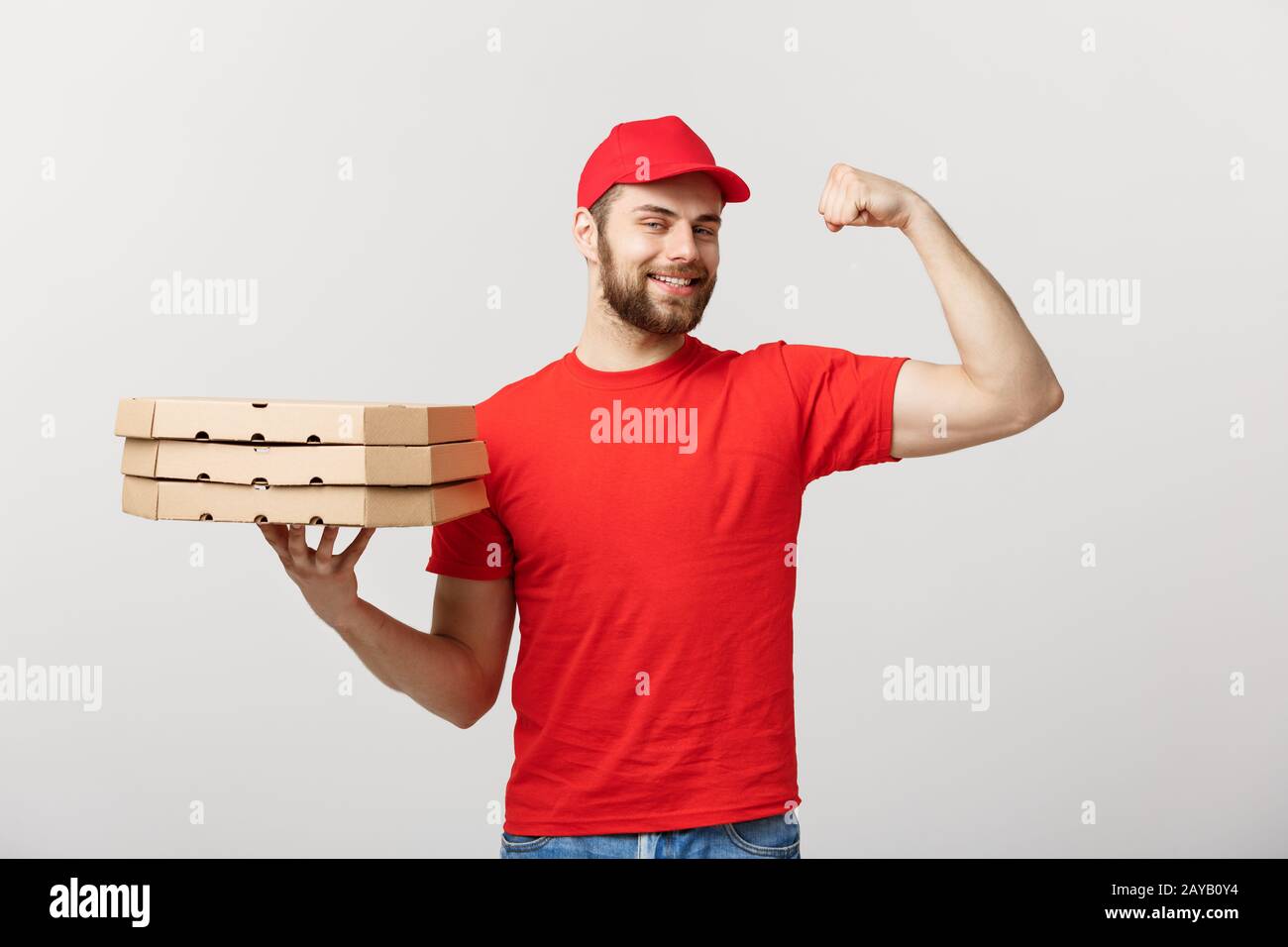 Delivery Concept - Portrait of Strong handsome delivery man flexing his ...