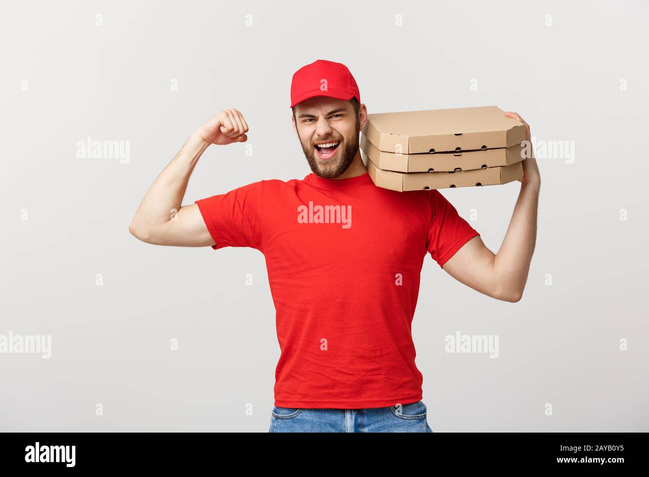 Delivery Concept - Portrait of Strong handsome delivery man flexing his ...