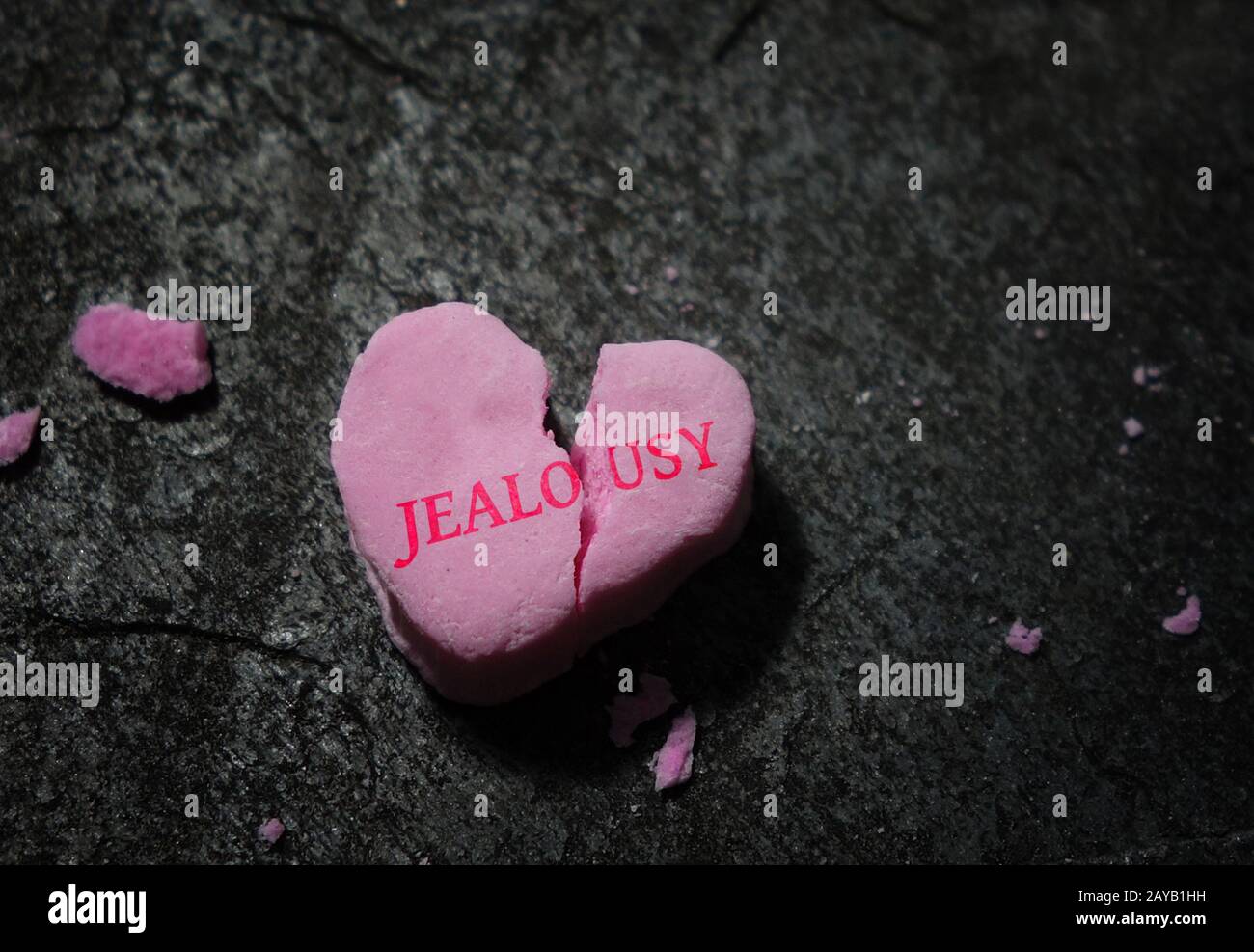 Jealousy candy heart Stock Photo - Alamy