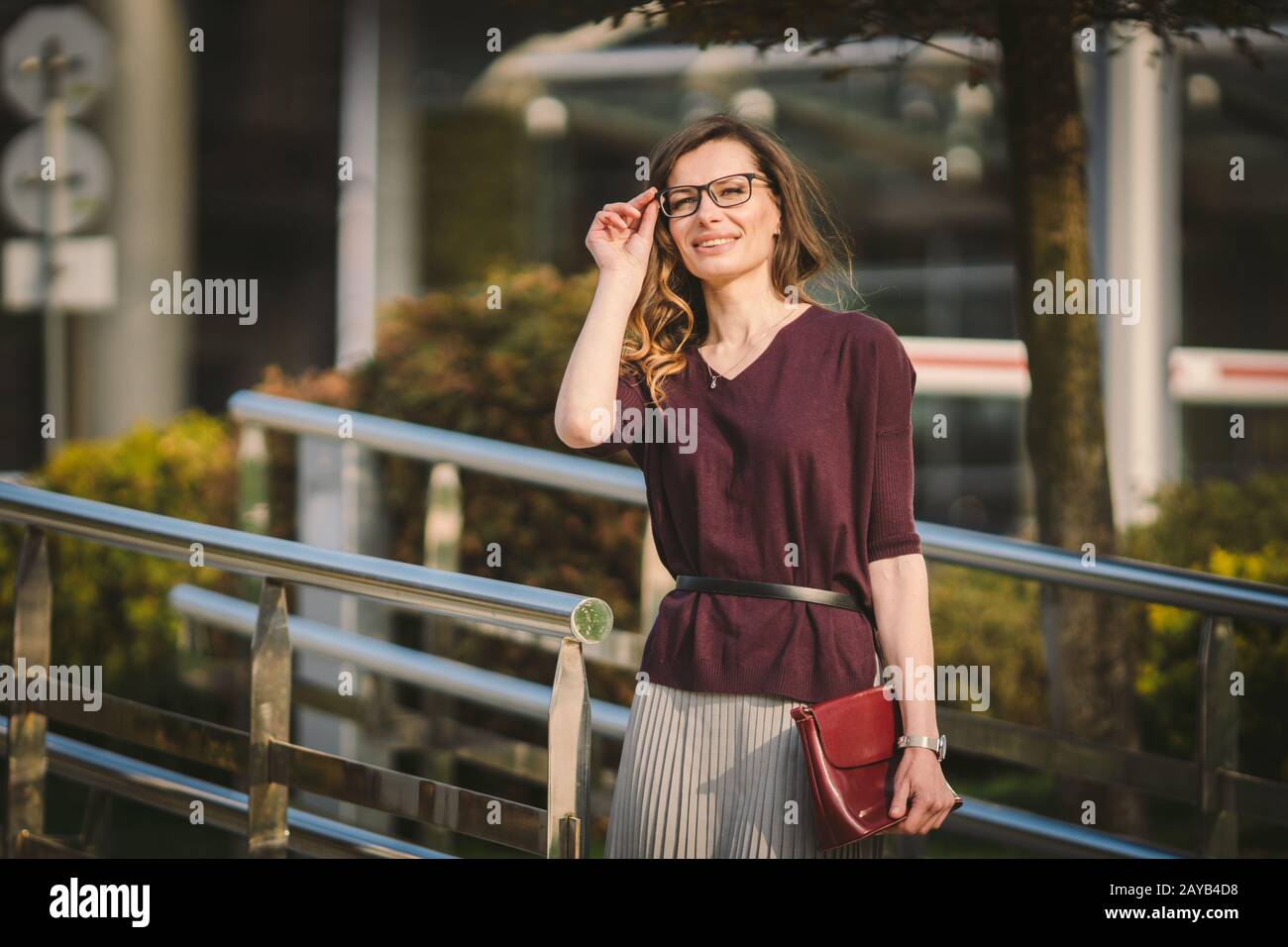 Caucasian adult lady woman in glasses posing near office building ...