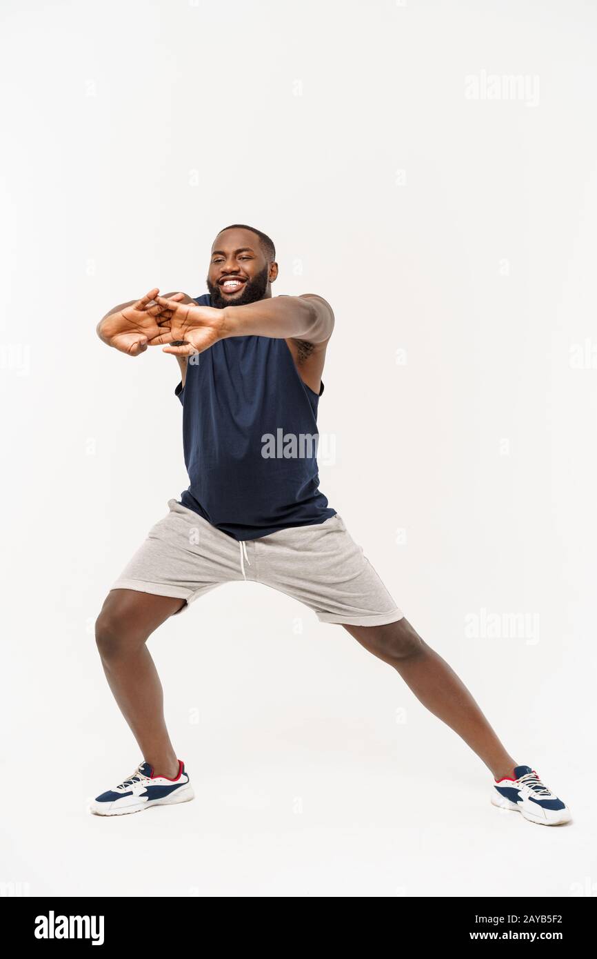 African sport man exercising and stretching on white background Stock ...