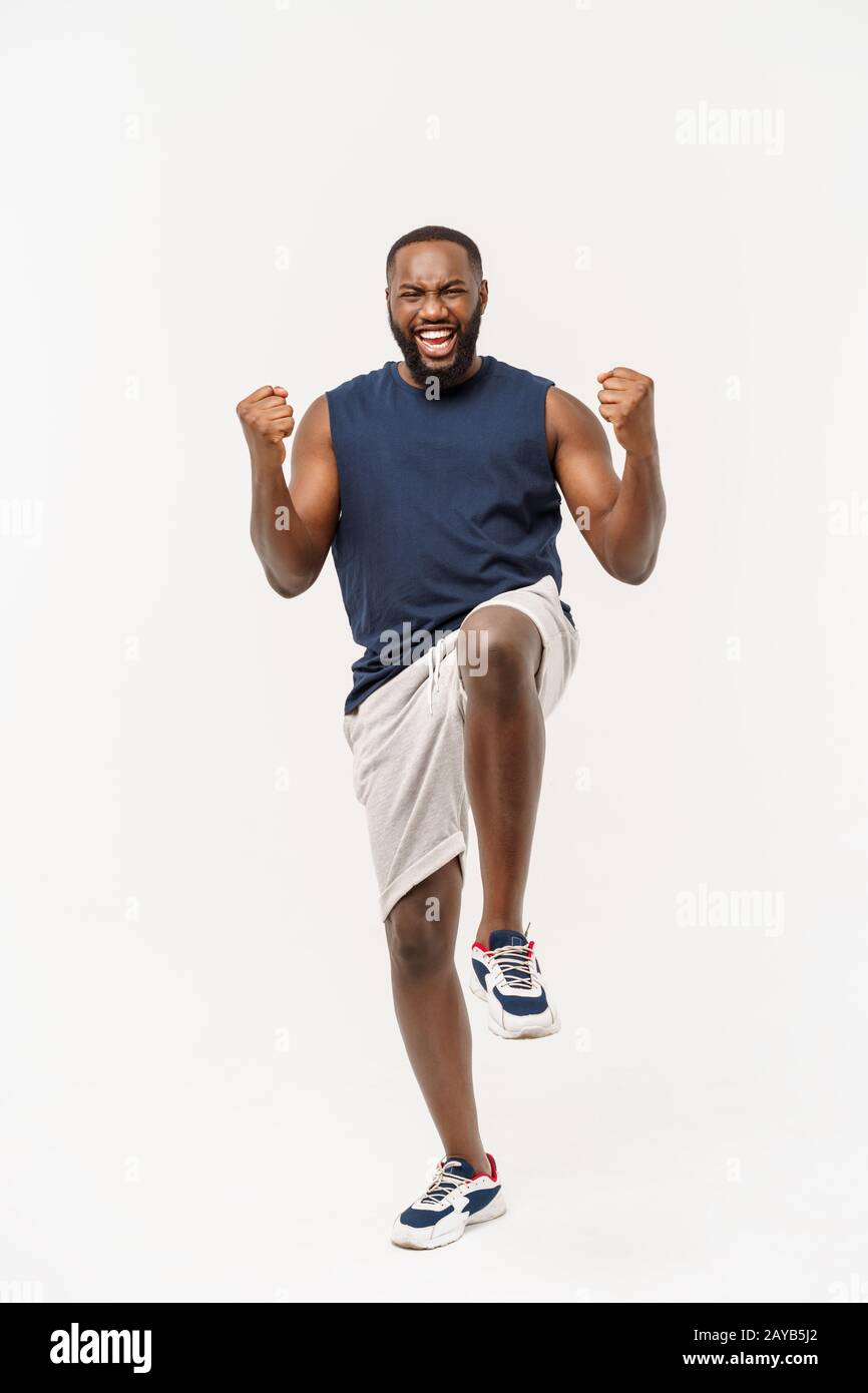 Young fitness african black man in sport wear cheering carefree and ...