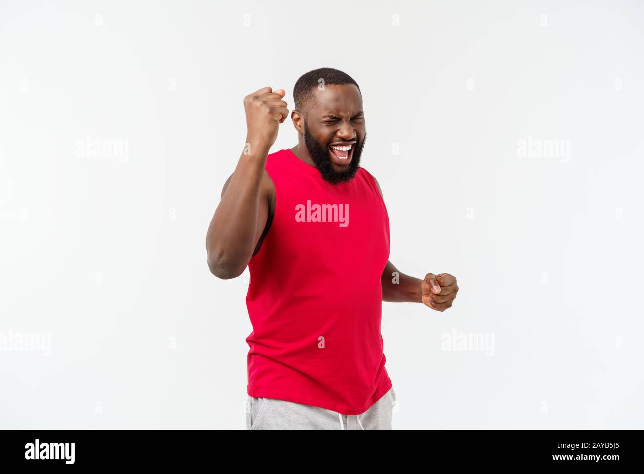Young fitness african black man in sport wear cheering carefree and ...