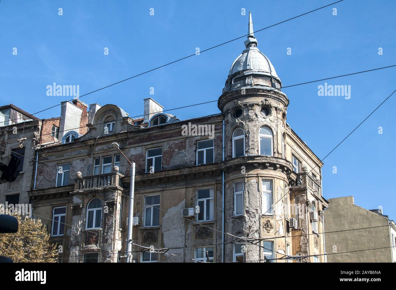 Old retro neglected beautiful city house building on clear blue sky ...