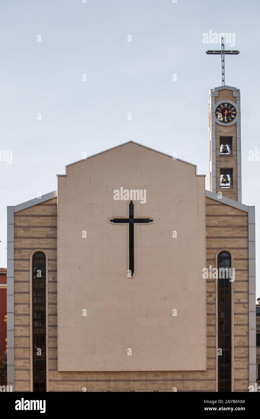 Contemporary catholic church building with bell tower and clock tower ...
